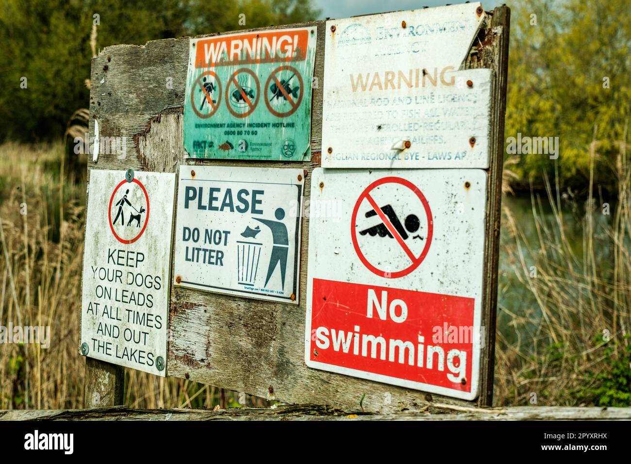 Collection Of Public Safety Notices By The Side Of A Lake With No ...