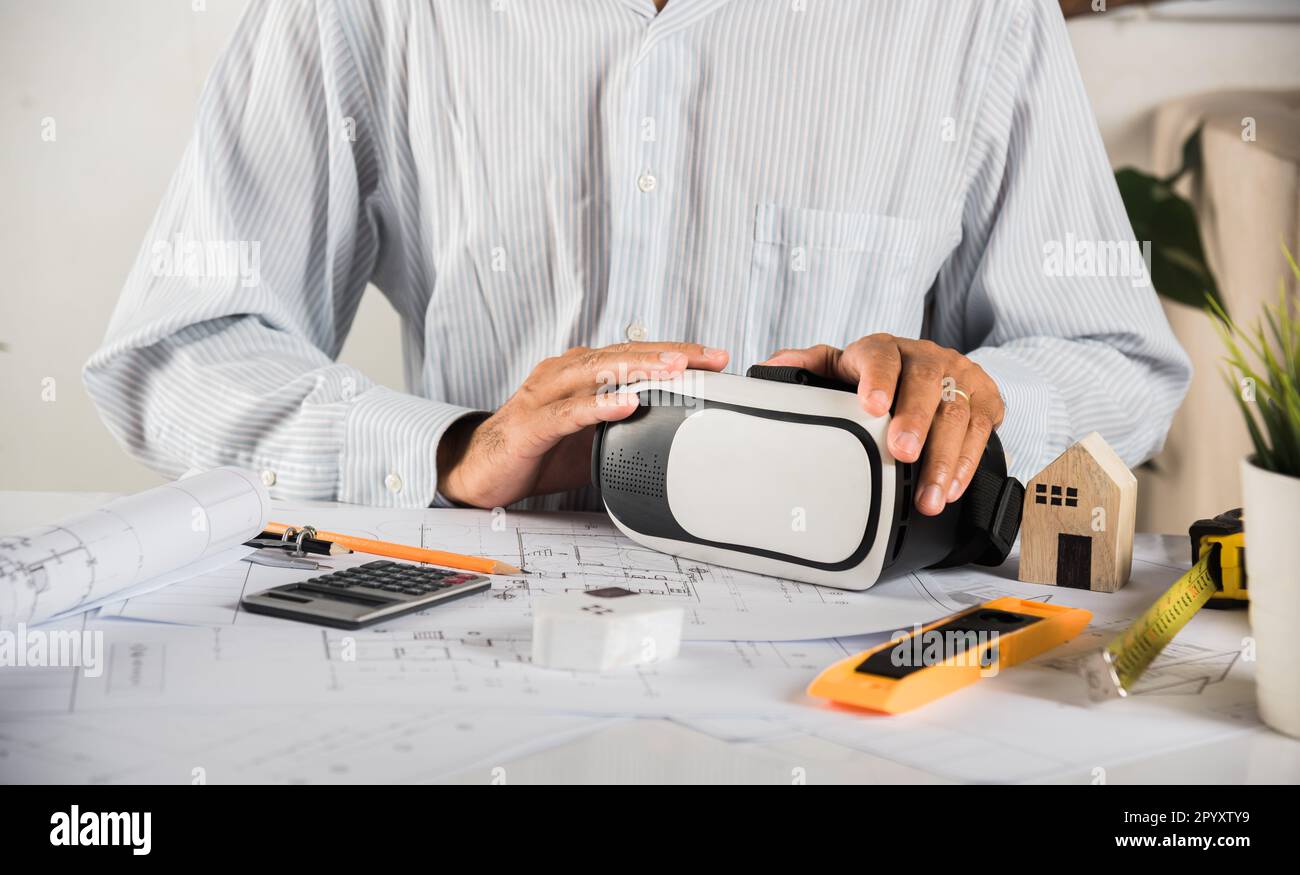 Architectural building design holding 3D VR glasses and construction ...