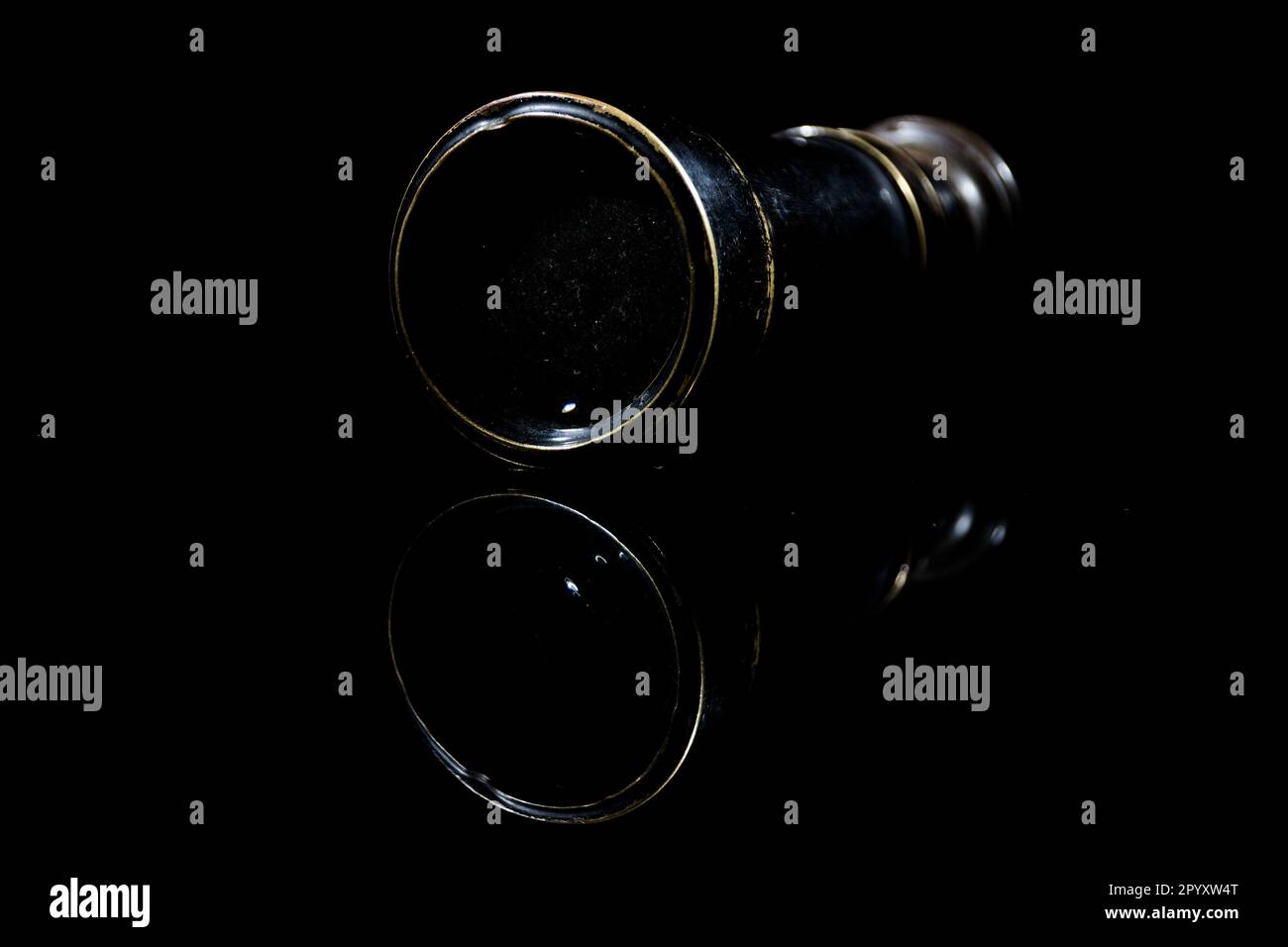 small vintage mono ocular spyglass on black surface with black background Stock Photo - Alamy