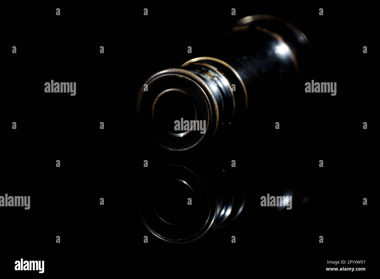 small vintage mono ocular spyglass on black surface with black ...