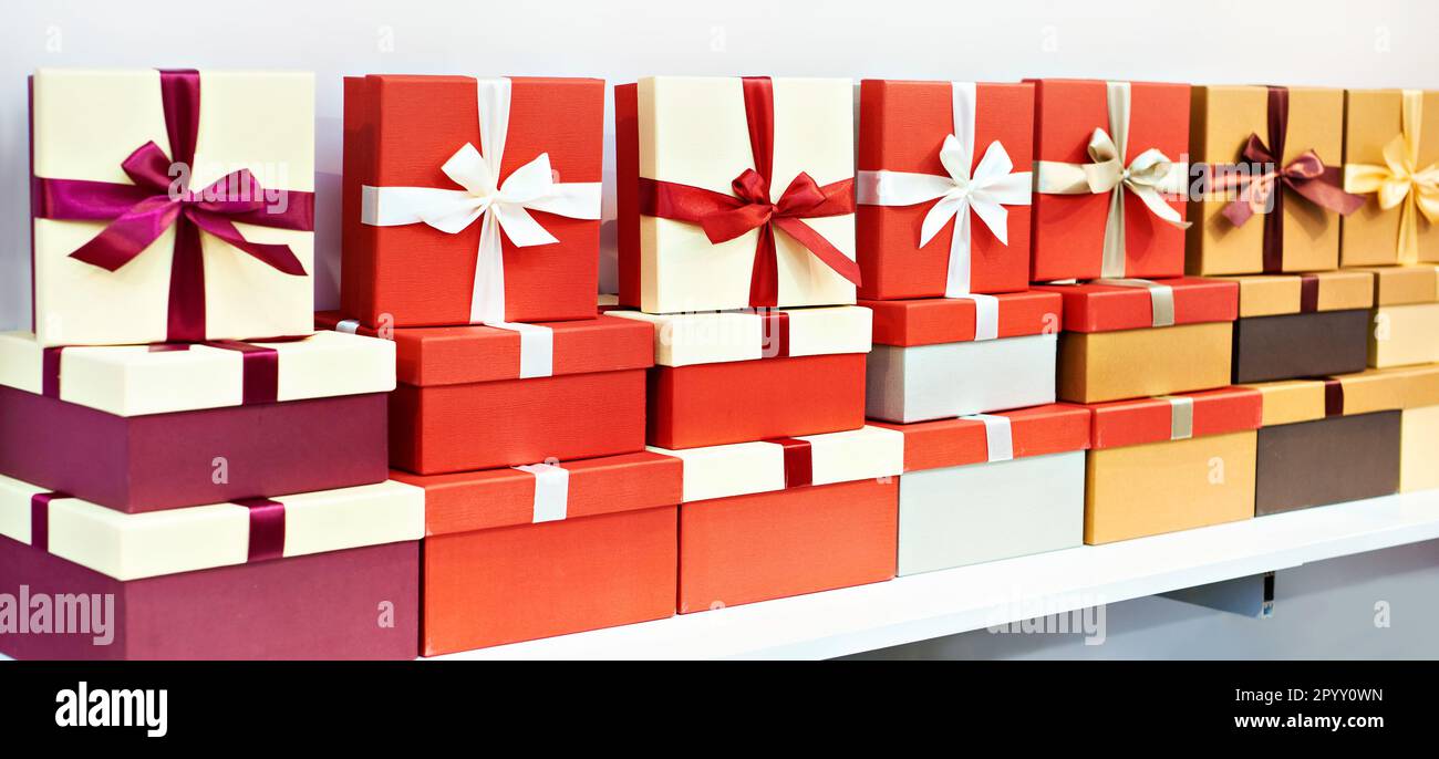 Gift boxes with ribbons on a store shelf Stock Photo - Alamy