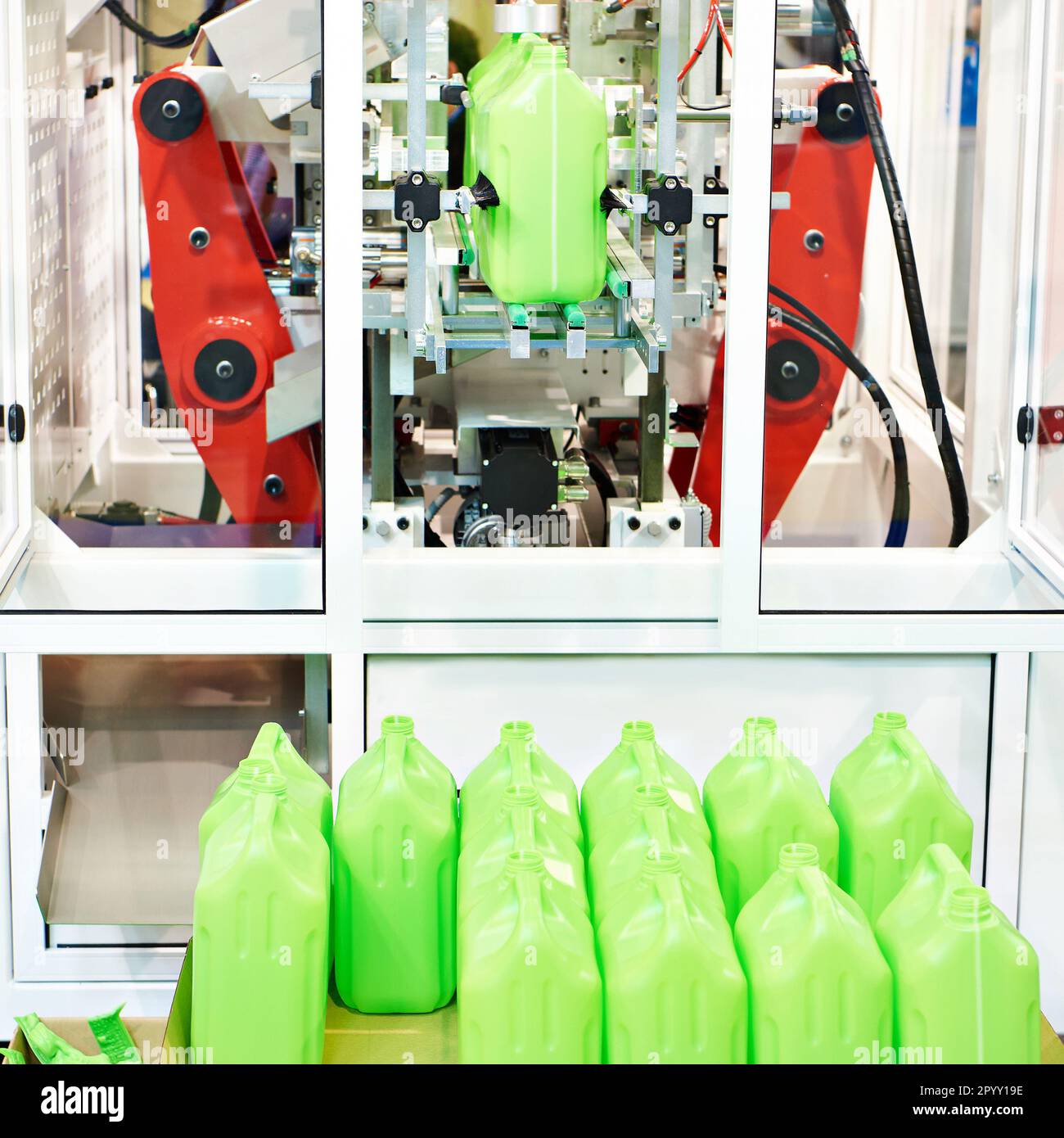 Plastic cans on a factory conveyor Stock Photo - Alamy