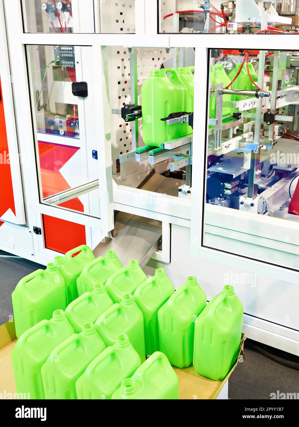 Plastic cans on a factory conveyor Stock Photo - Alamy