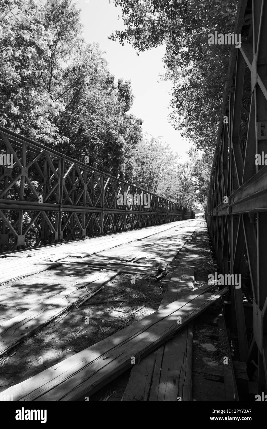Time-worn and timeless: An old bridge with wooden planks and iron ...