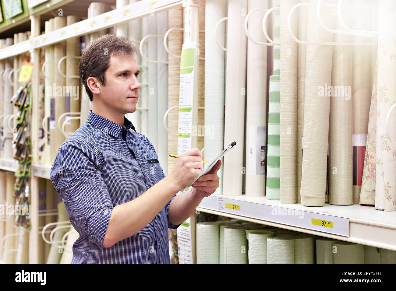 Man shopping wallpapers in DIY shop for construction Stock Photo - Alamy