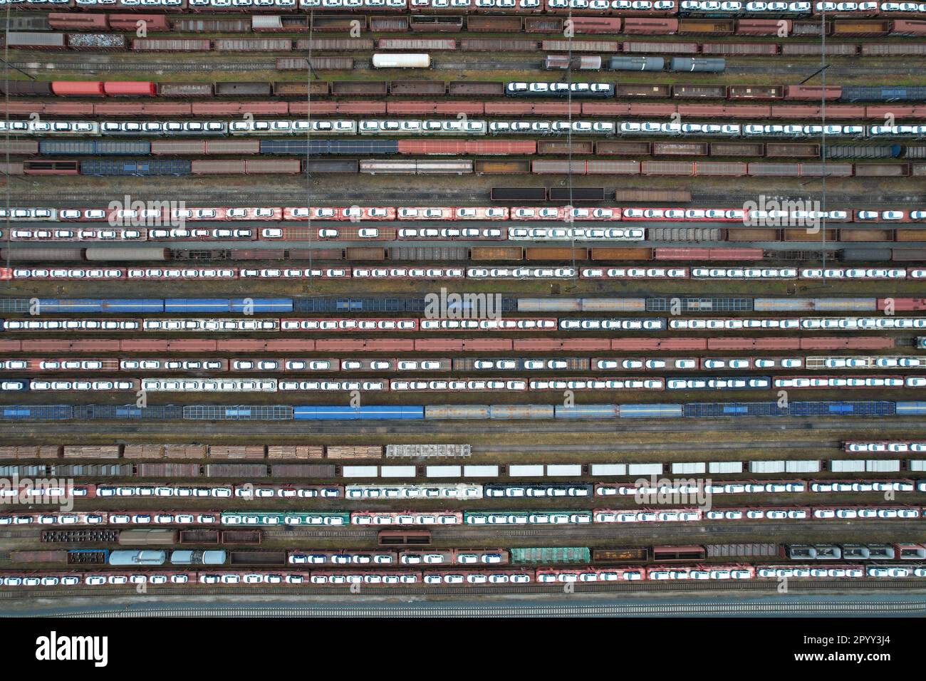 An aerial view of a train yard with multiple railway lines, with cars ...