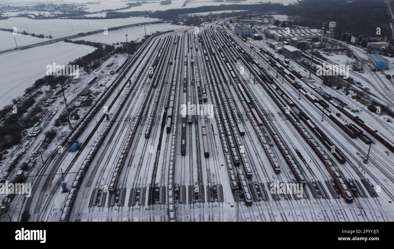 An aerial view of a train yard with multiple railway lines, with cars ...