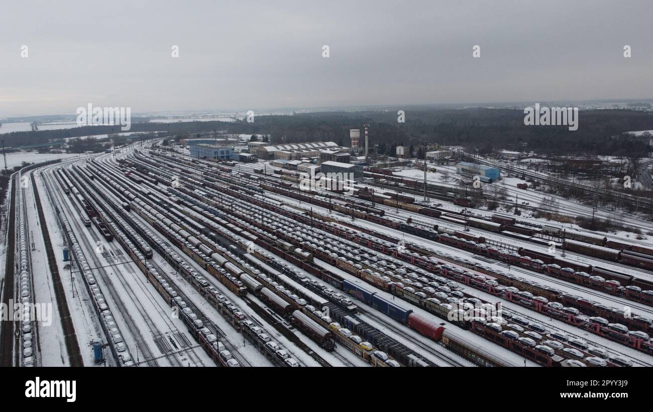 An aerial view of a train yard with multiple railway lines, with cars ...