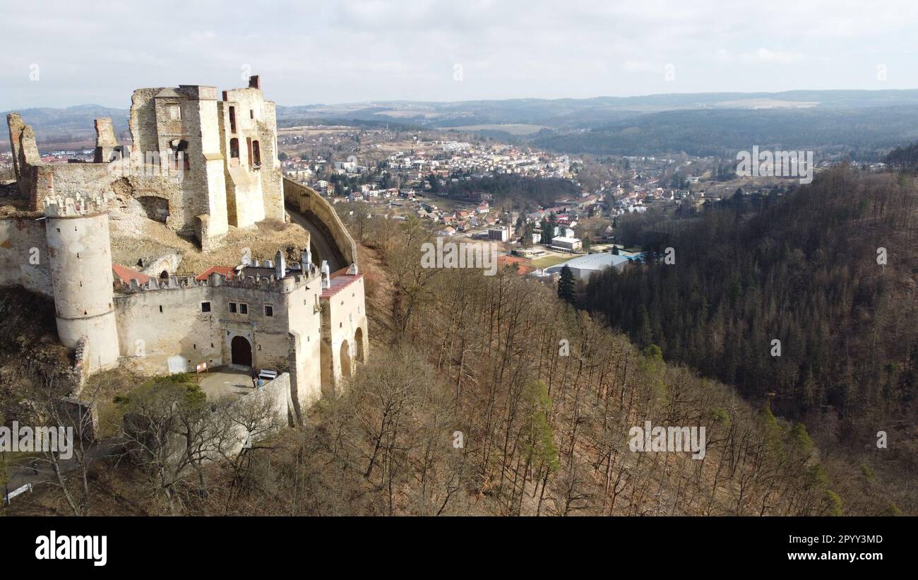 A stone medieval castle surrounded by a lush forest landscape featuring ...