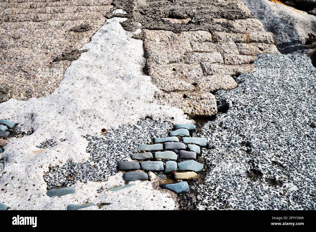 Piecemeal repairs carried out on seawall using different concretes and ...