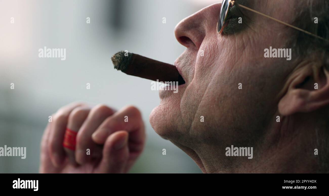 Older man enjoying cigar outside hi-res stock photography and images ...