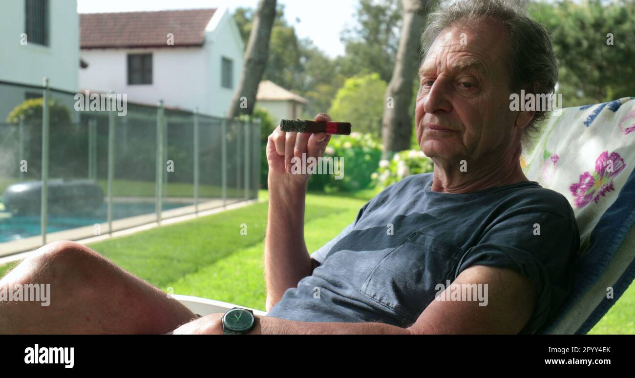 Older man enjoying cigar outside hi-res stock photography and images - Alamy