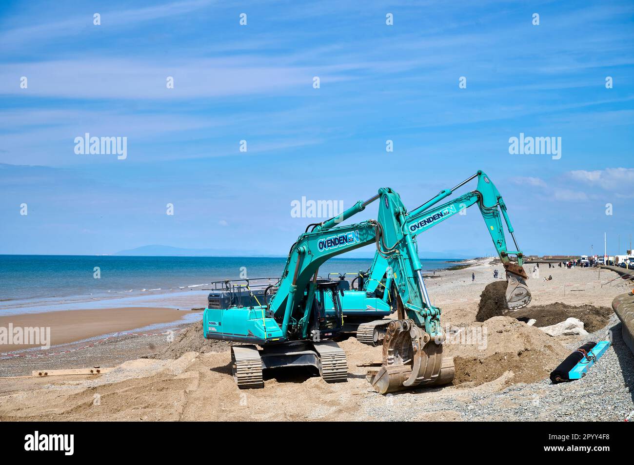 Earth movers working on Cleveleys beach and seawall Stock Photo - Alamy