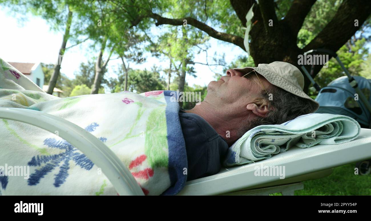 Man napping under a tree hi-res stock photography and images - Alamy