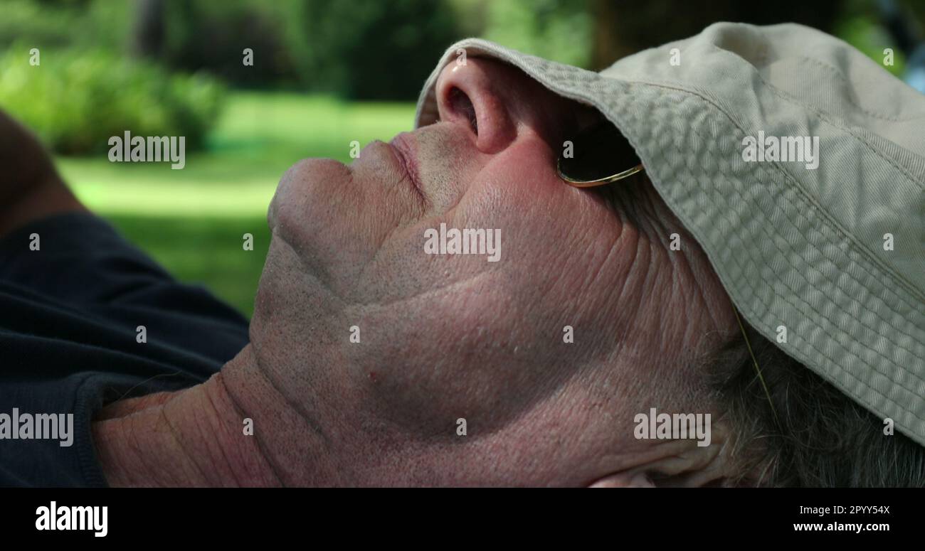 Older taking a break resting outside napping. Senior retired man ...