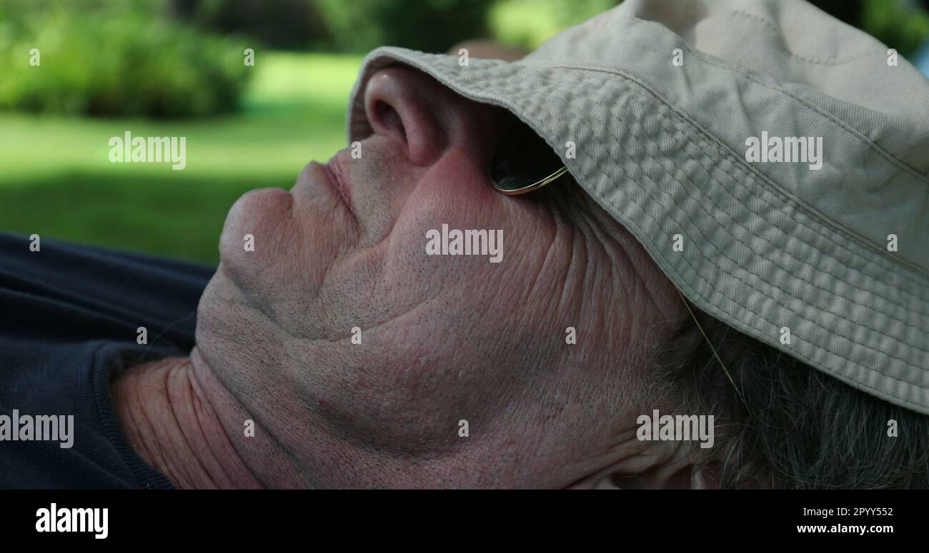 Older taking a break resting outside napping. Senior retired man ...