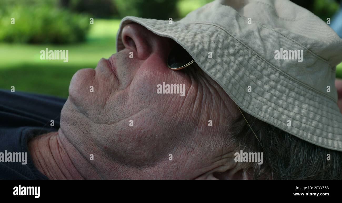 Older taking a break resting outside napping. Senior retired man ...