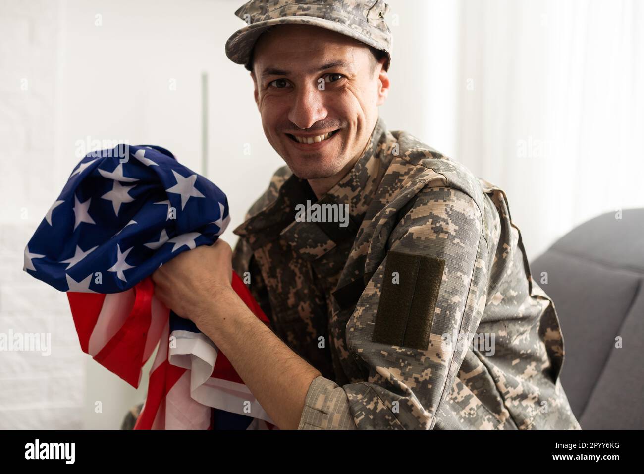 upset American soldier holding flag of United States while crying ...