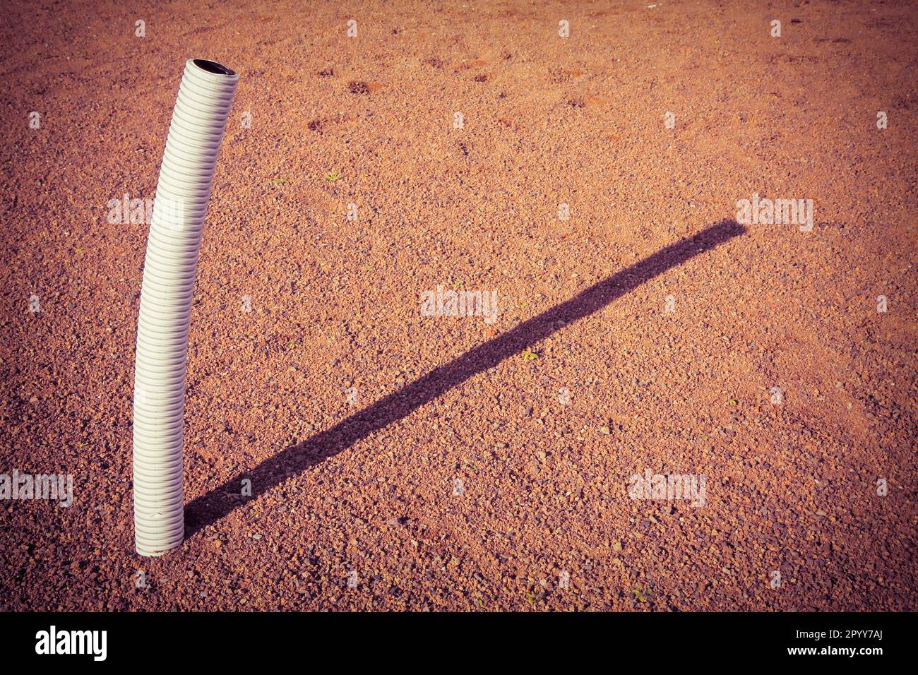 Flexible plastic pipe with electric cable coming out from the ground ...