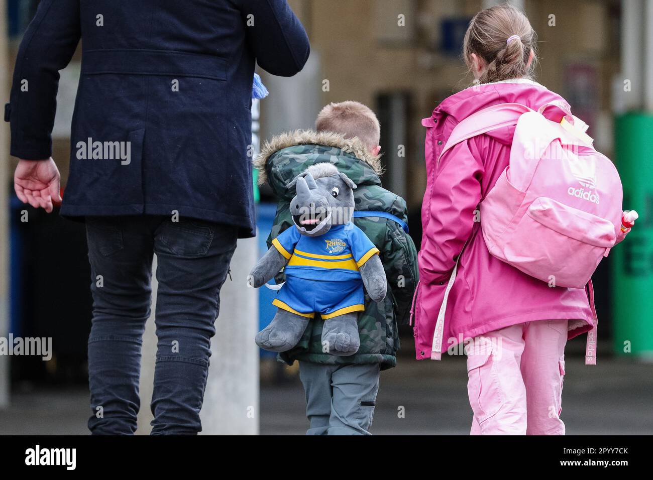 A young Leeds Rhinos supporter carries his Ronnie the Rhino bag into ...