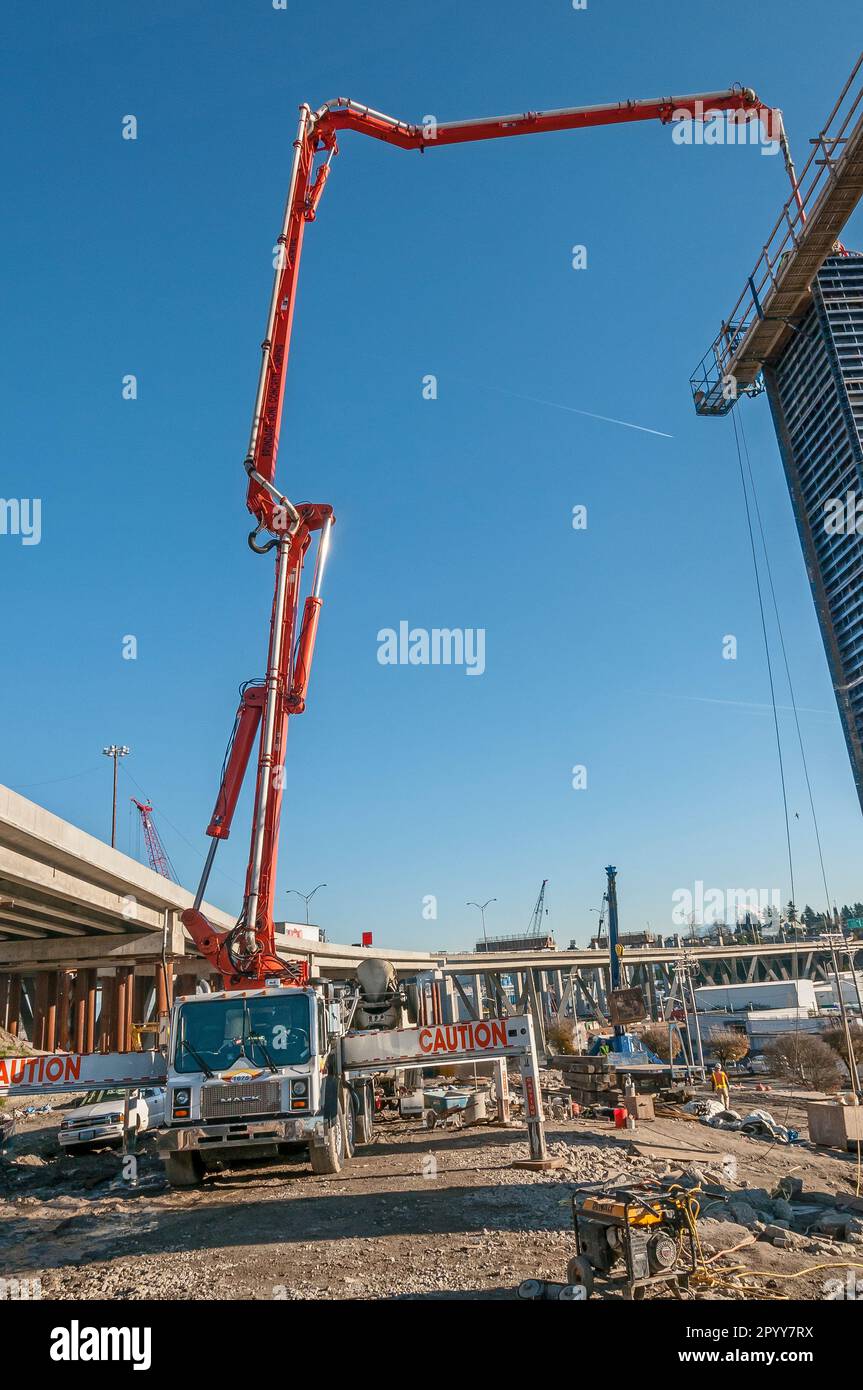 Pumping and pouring concrete into pilings for an elevated highway ...