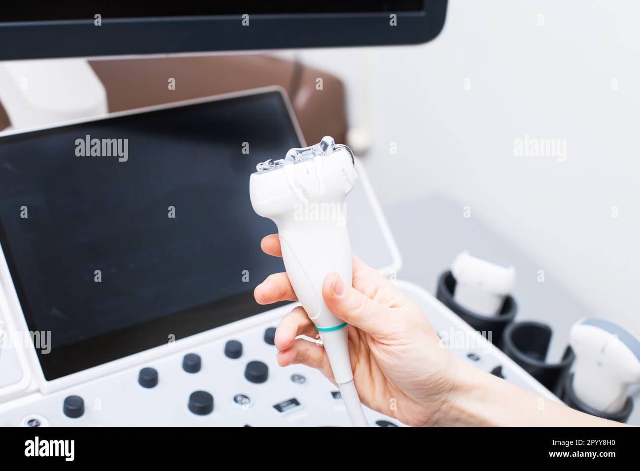 Woman doctor's hand aholding a medical gel to ultrasonic sensor of ...