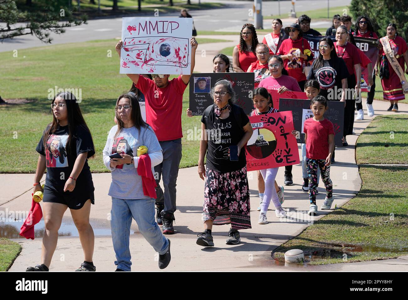 People participate in a memorial walk at the state Capitol on Missing ...