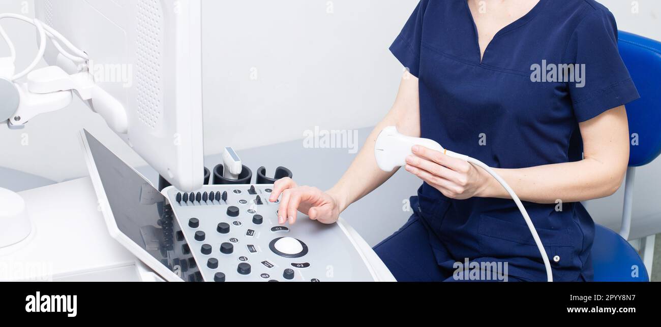 Female doctor sitting in office in a hospital doing ultrasound scanning ...