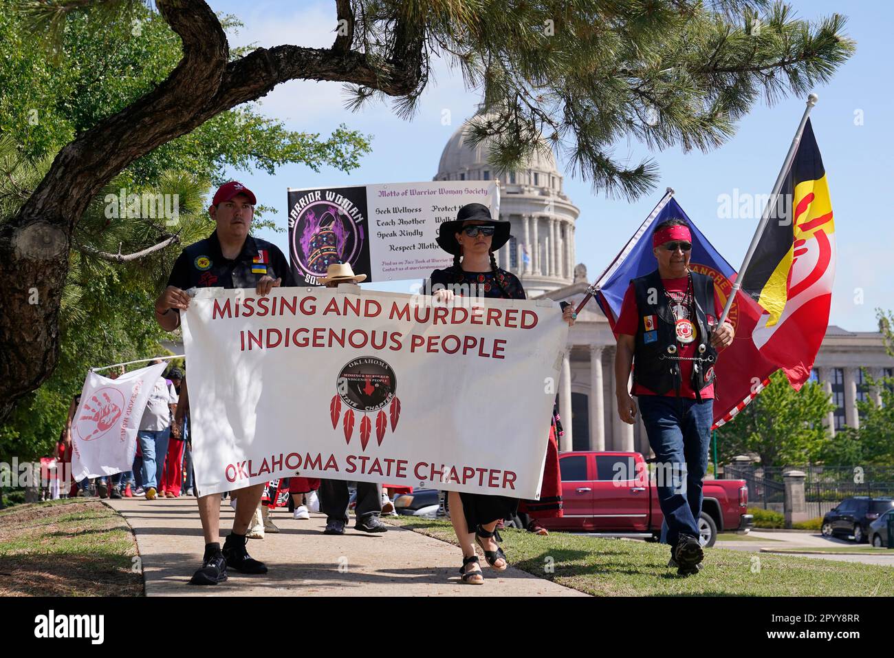 People participate in a memorial walk at the state Capitol on Missing ...