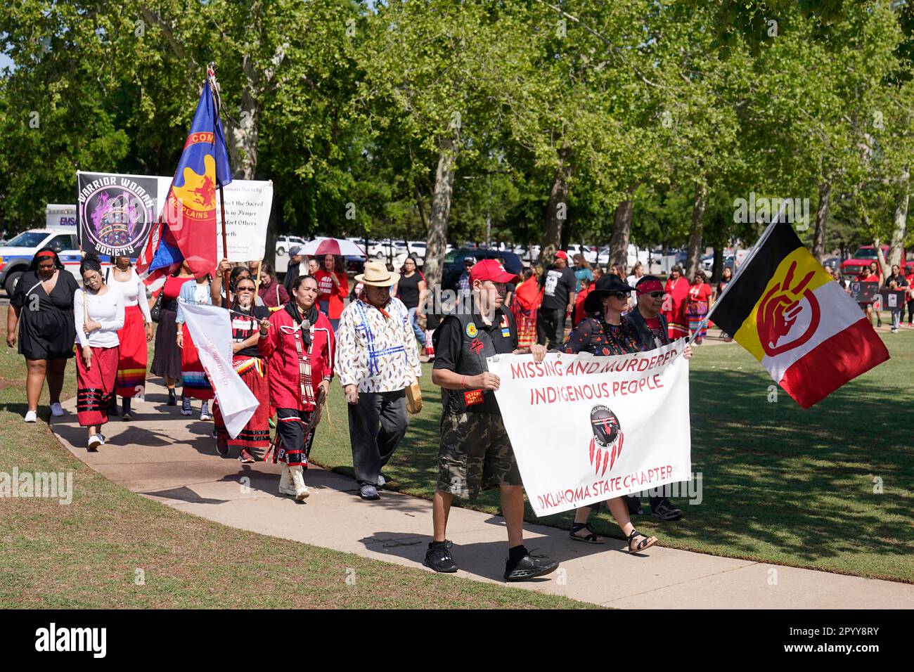 People participate in a memorial walk at the state Capitol on Missing ...