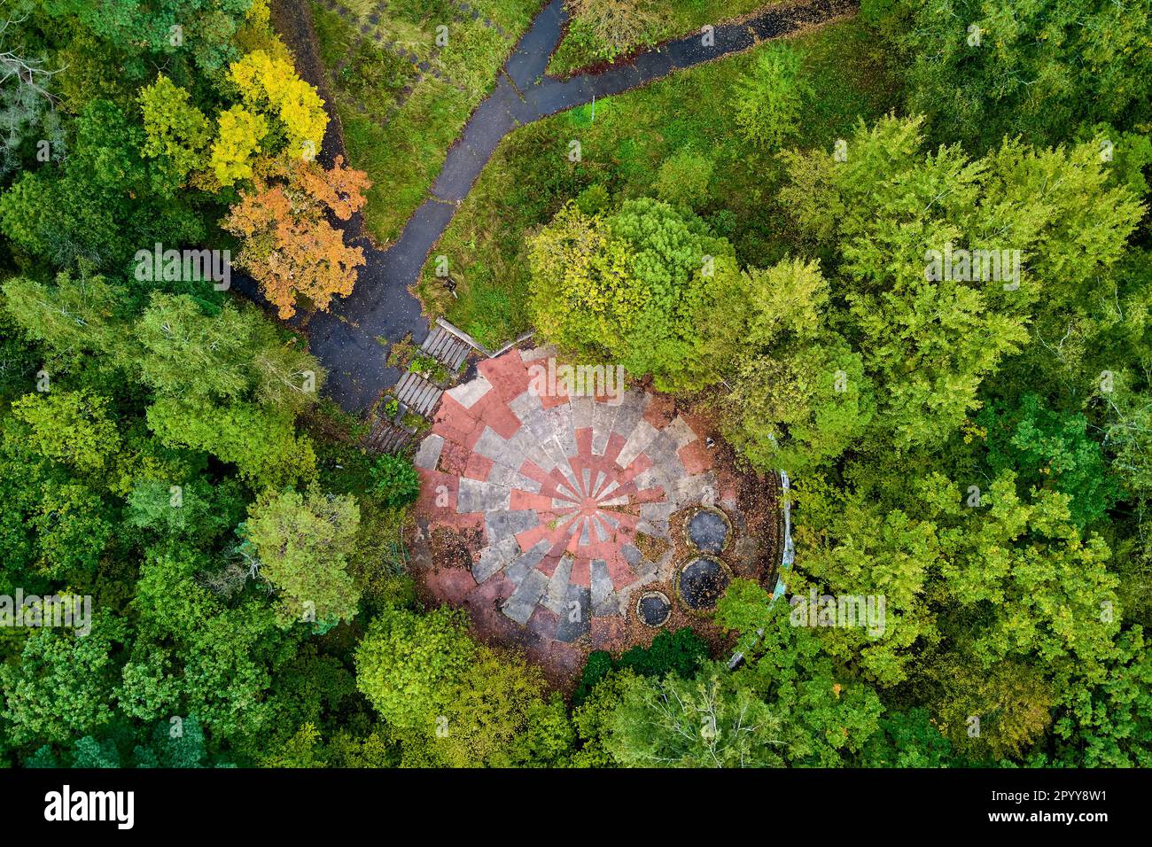 Aerial view of an old park with a dance floor surrounded by greenery ...
