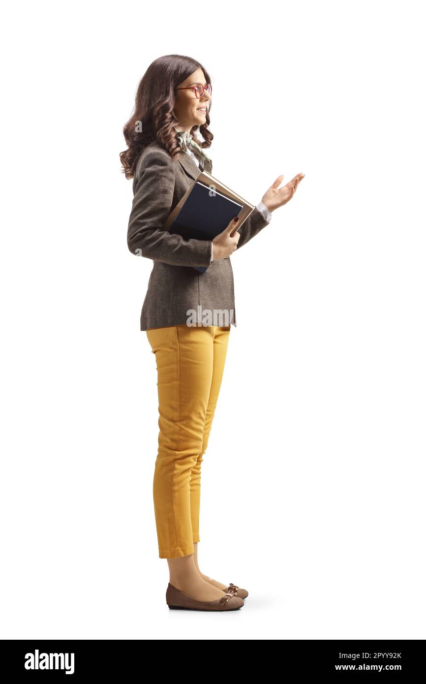 Full length profile shot of a young woman in formal clothing holding ...