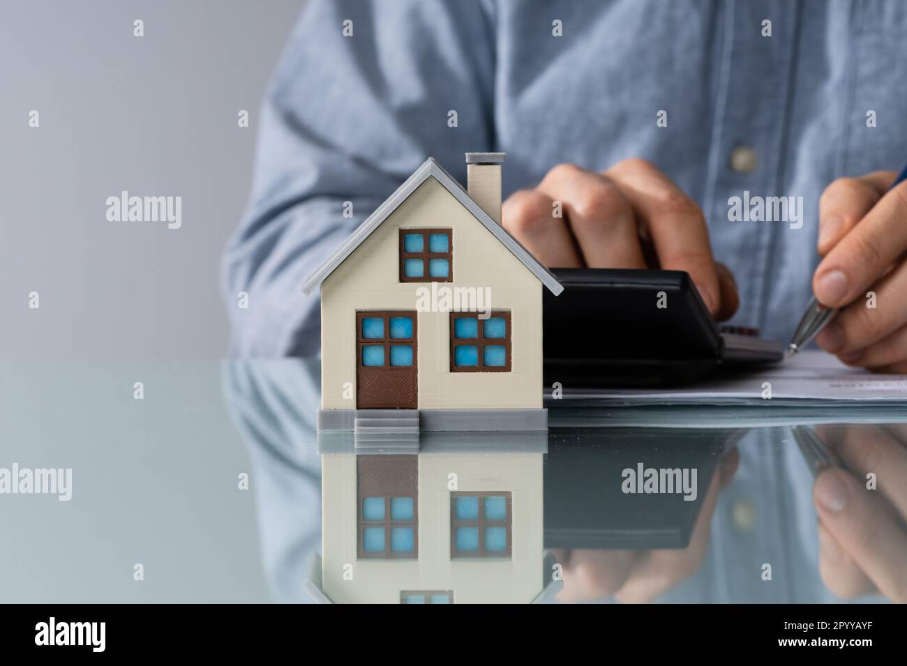 Close-up Of A Person Hand Doing Property Tax Calculation Using ...