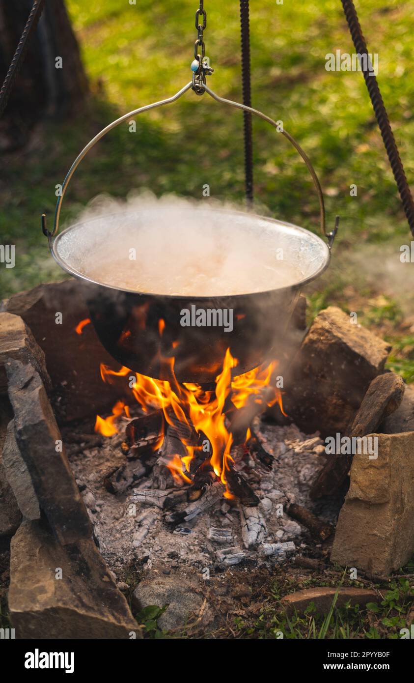 Delicious meal (goulash) made on traditional way in fish pot on camp ...