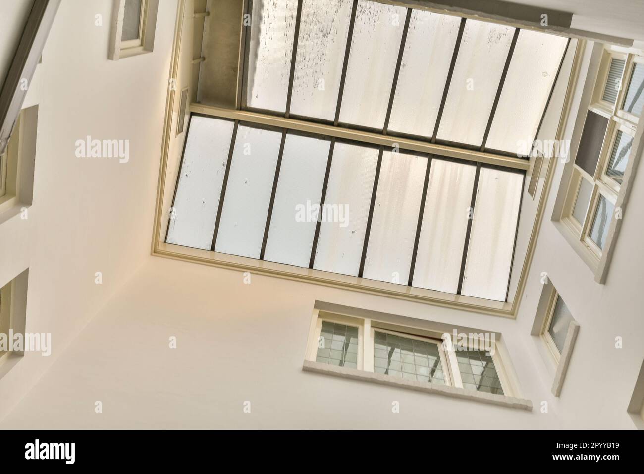 the inside of a building with multiple windows and mirrors hanging from ...