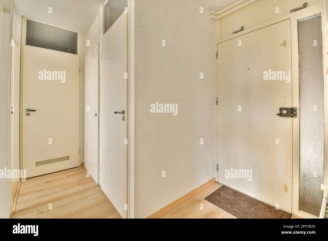 an empty room with white walls and wood flooring on either side by two ...