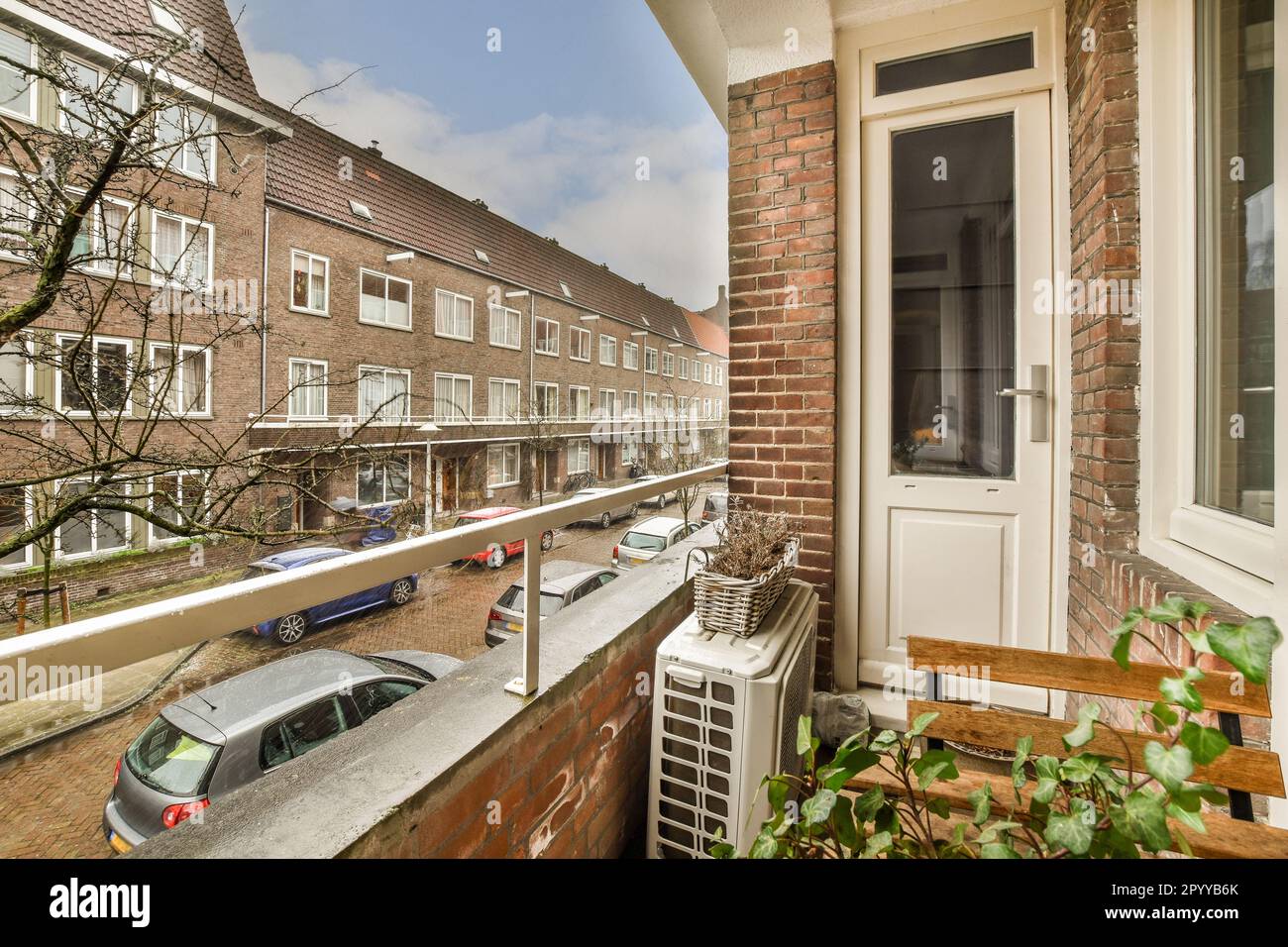 an outside area with cars parked on the street and houses in the ...