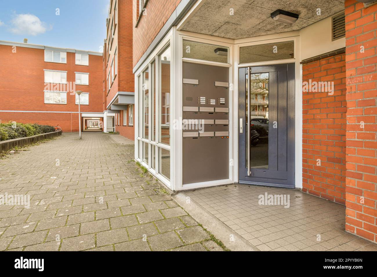 a brick building with an open door in the front and two windows on ...