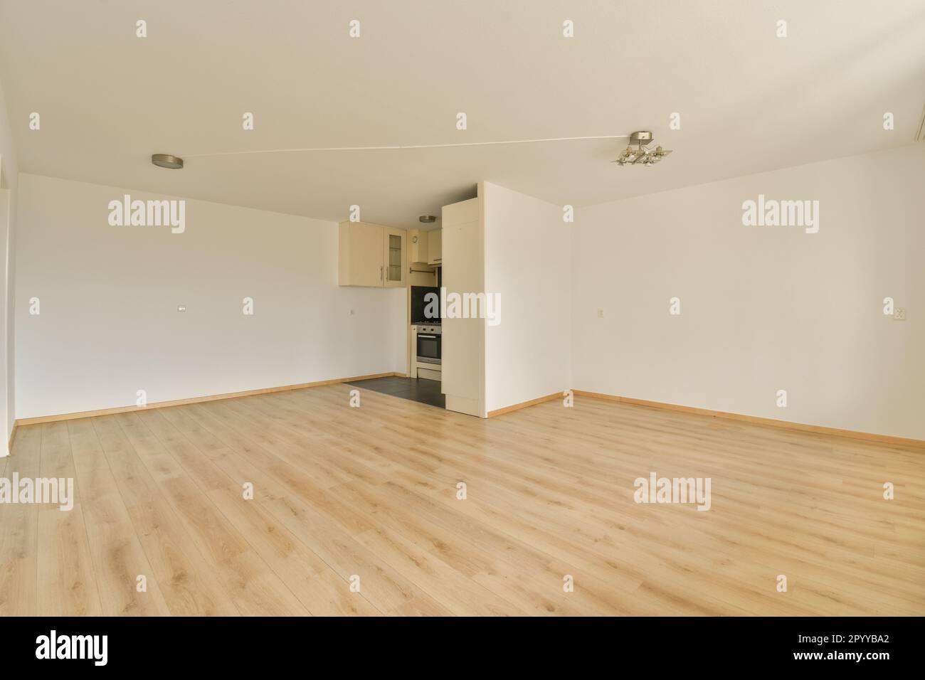 an empty living room with wood flooring and white walls in the room is ...