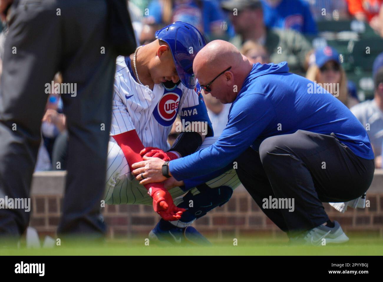 Chicago Cubs' Miguel Amaya gets his arm checked out after being struck ...