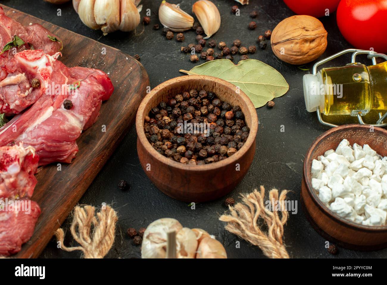 front view raw meat slice with fresh vegetables and seasonings on dark ...