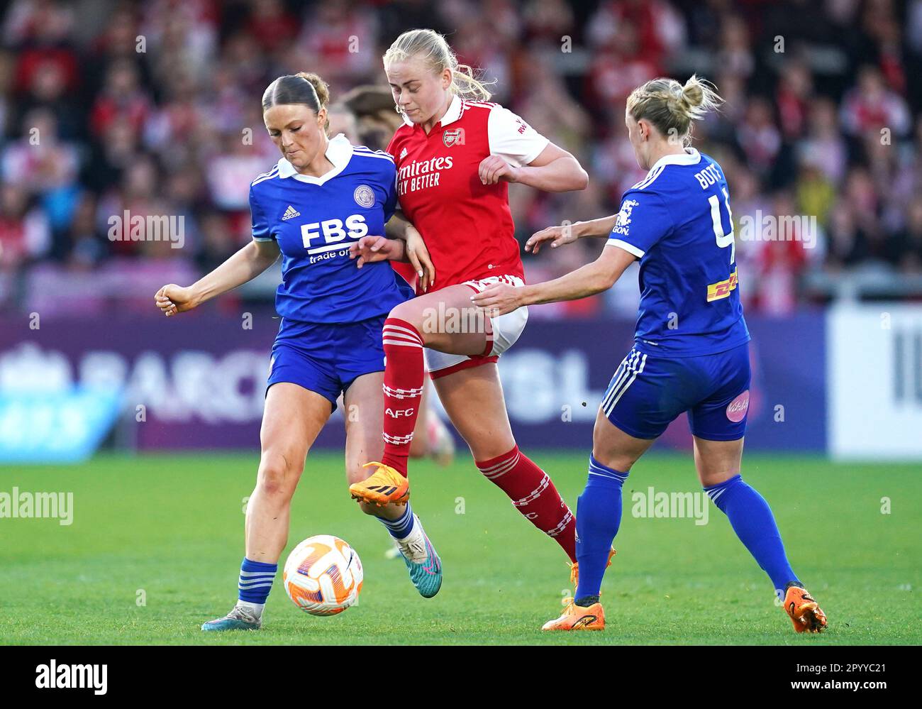 Arsenal's Kathrine Moller Kuhl (centre) battles for the ball with ...