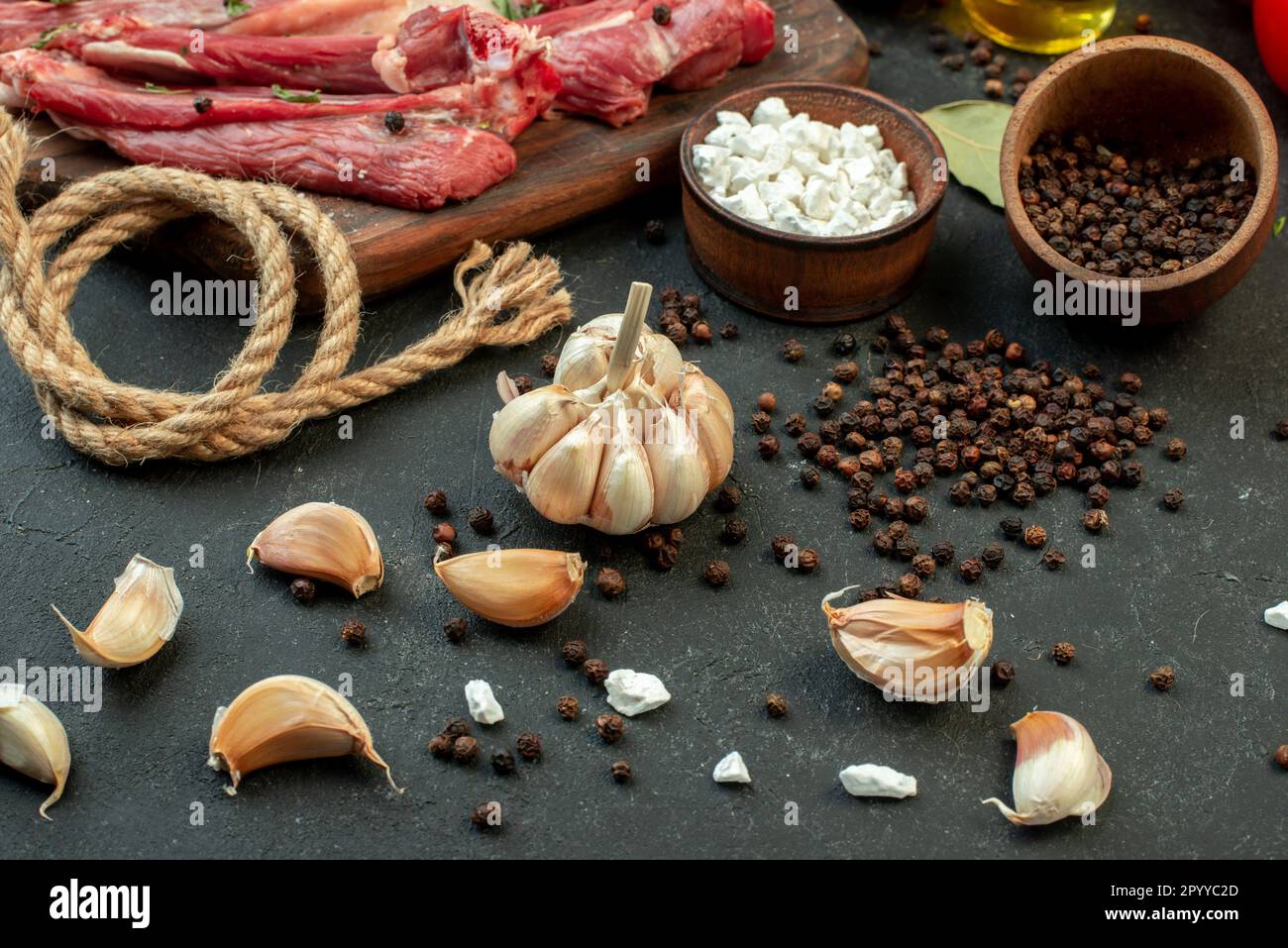front view raw meat slice with fresh vegetables and seasonings on dark ...