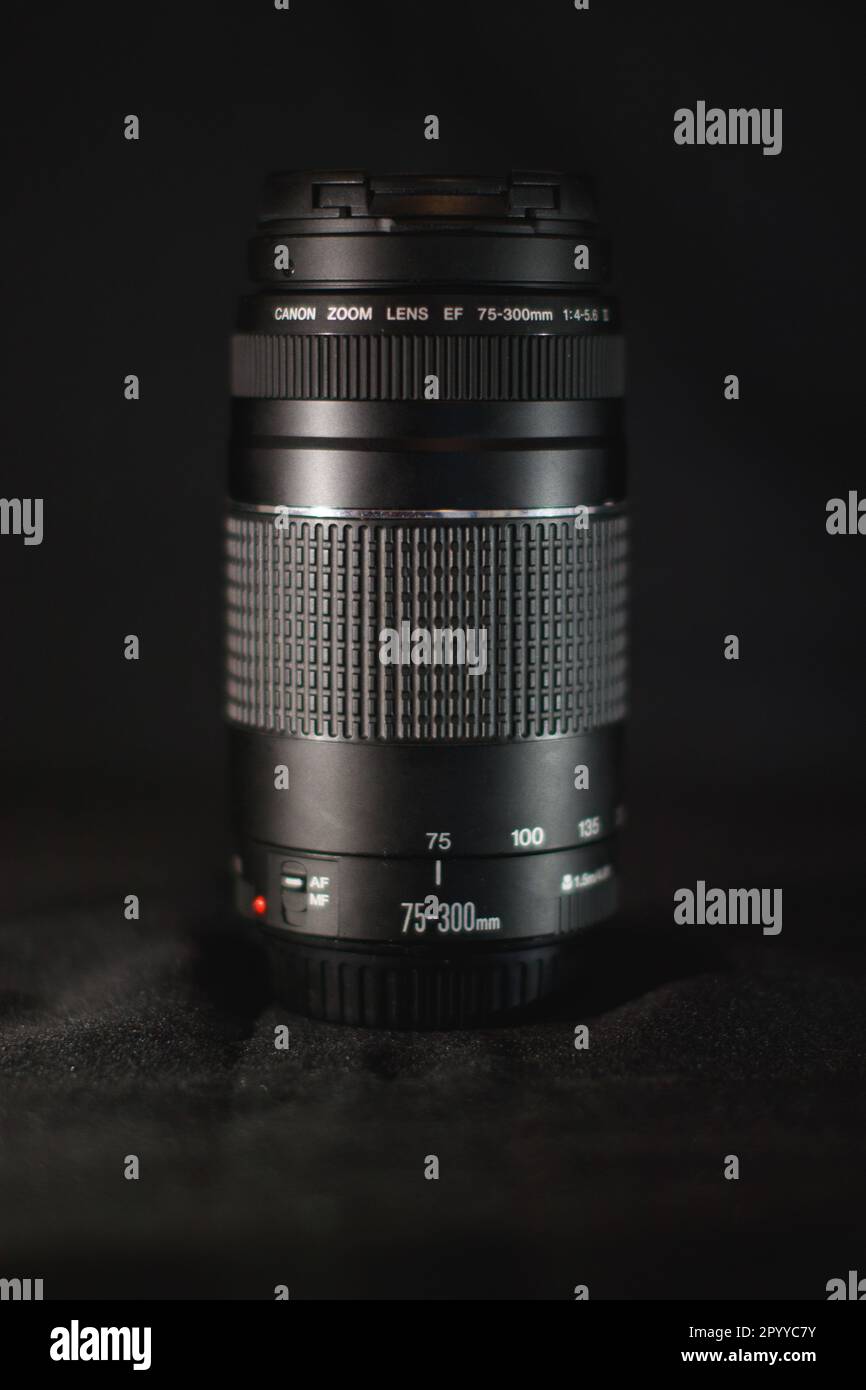 A Canon Prime Lens is captured in a minimalistic setting with a black ...