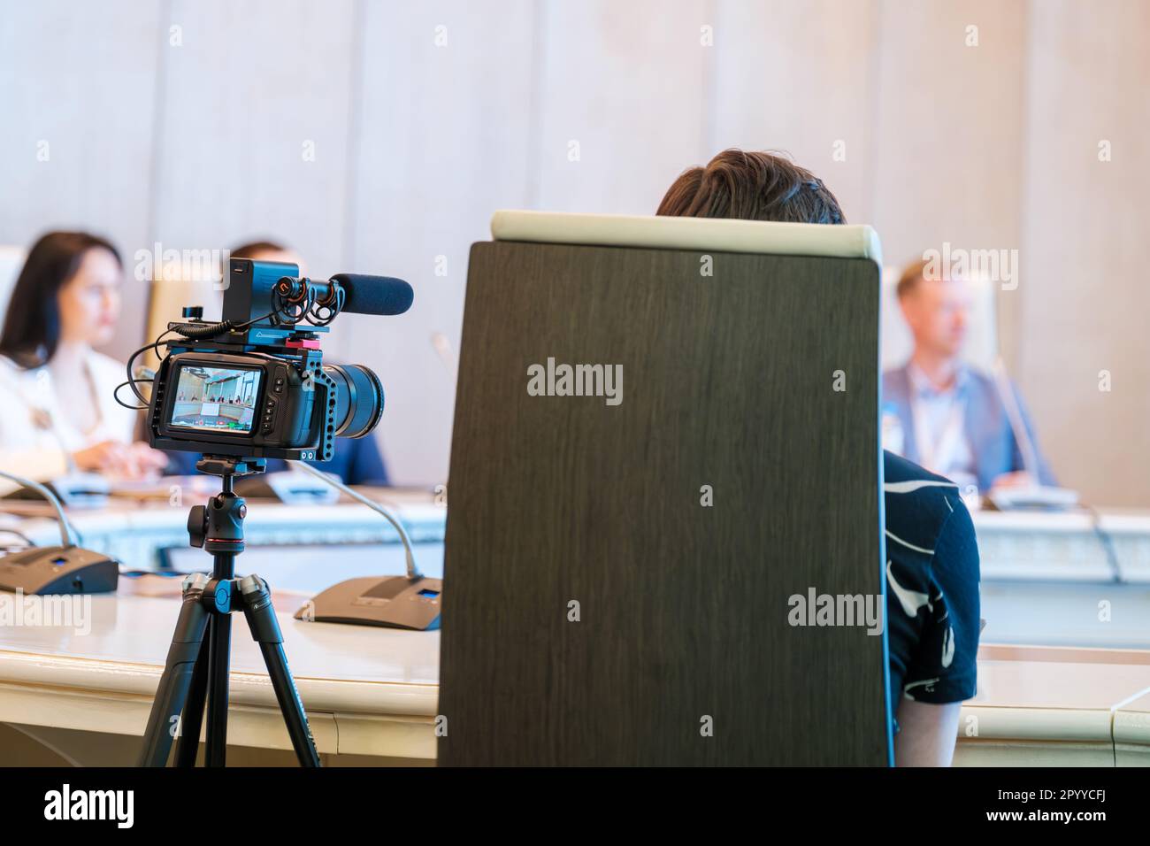 Group of people sitting at round table during business meeting recorded ...