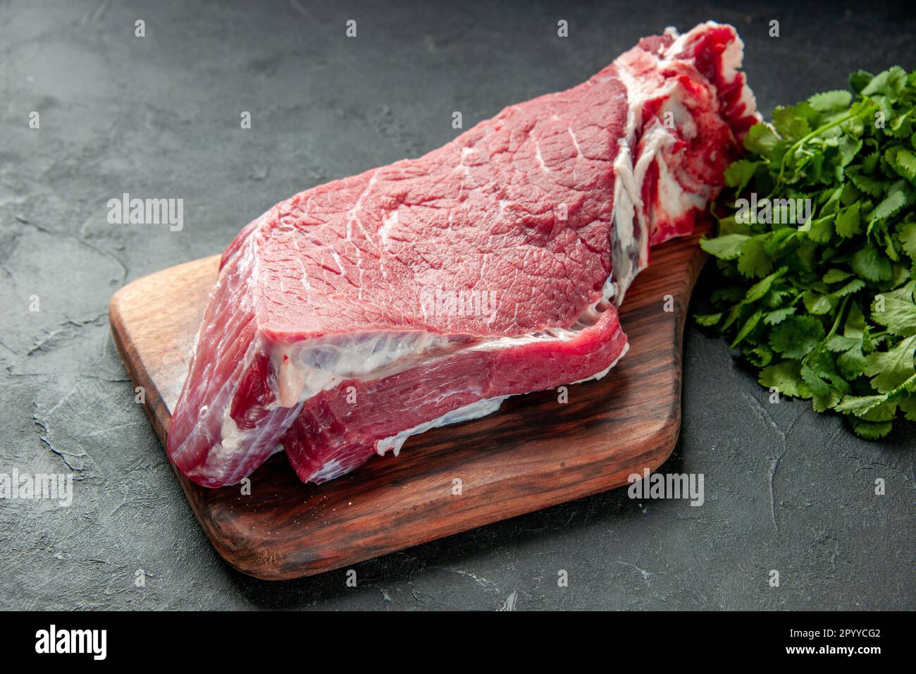 front view raw meat sliced with greens on dark background color food ...