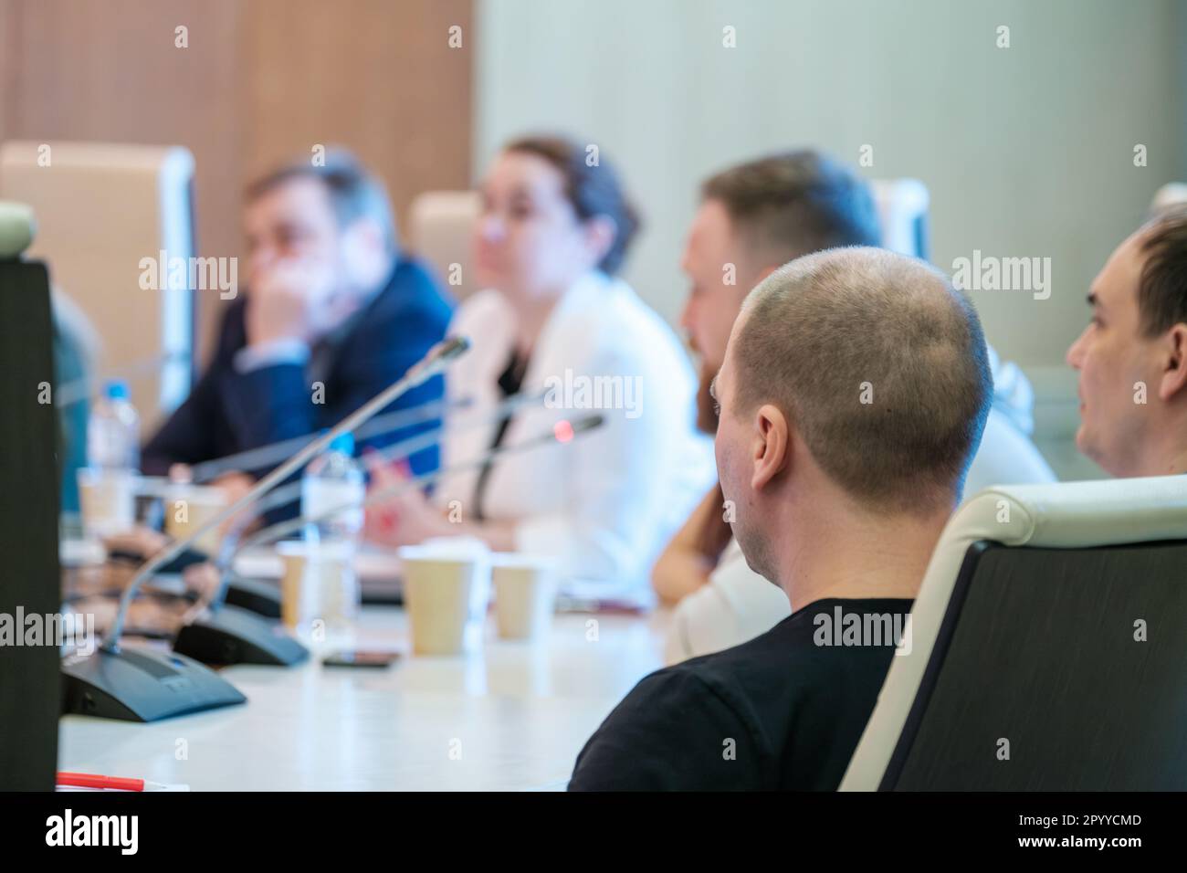Businesspeople at round table during meeting Stock Photo - Alamy