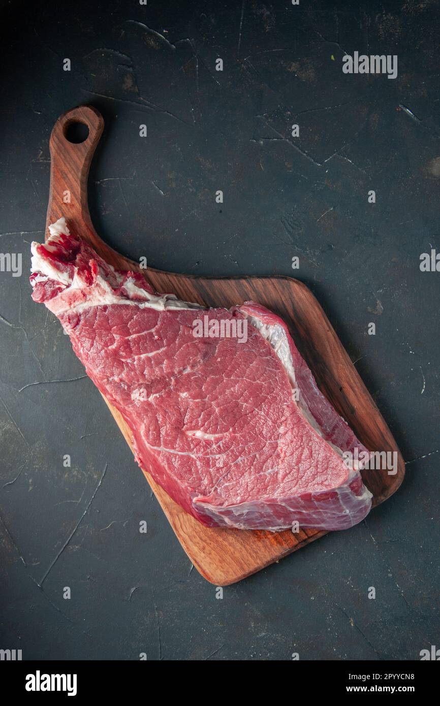 top view big meat slice on a dark background color butcher meal food ...