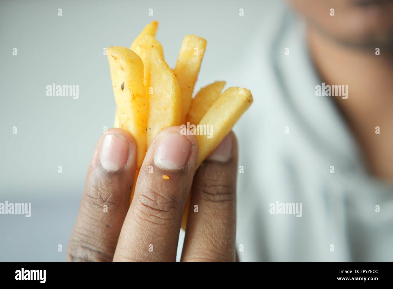 men eating french fries close up Stock Photo - Alamy