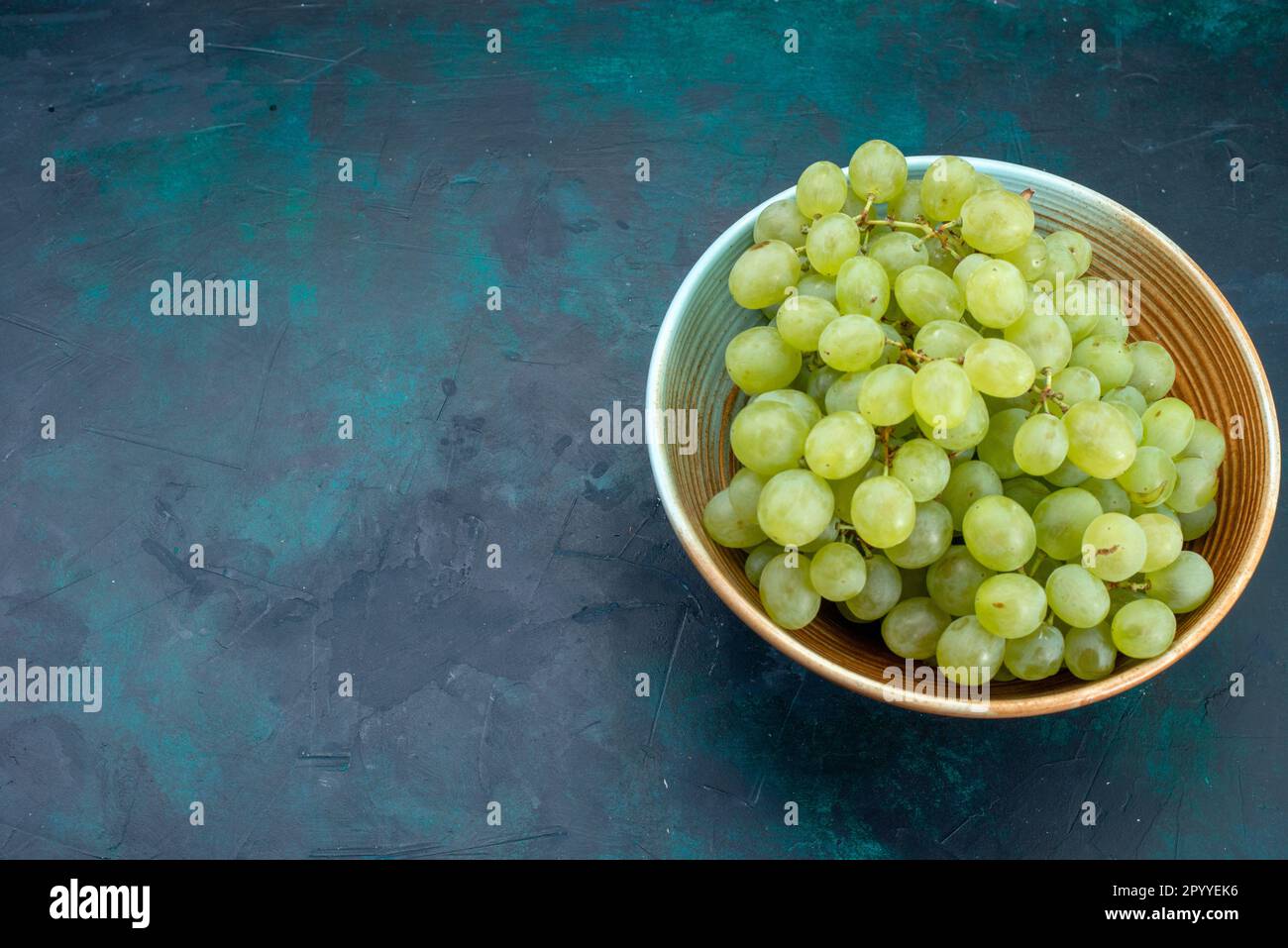 front view fresh green grapes inside plate on dark-blue desk fruit ...